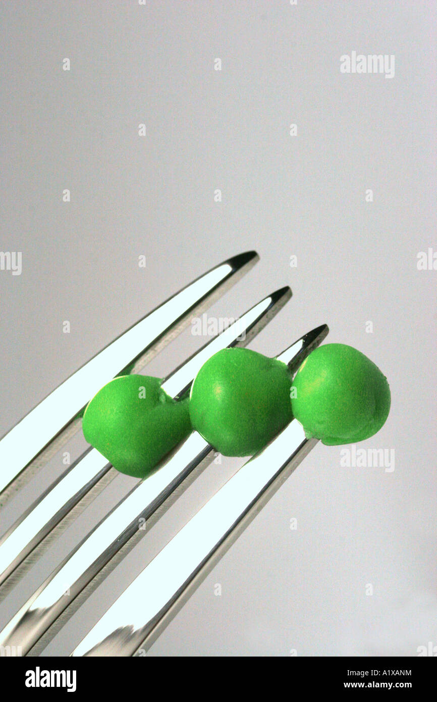 a fork with green peas Stock Photo - Alamy