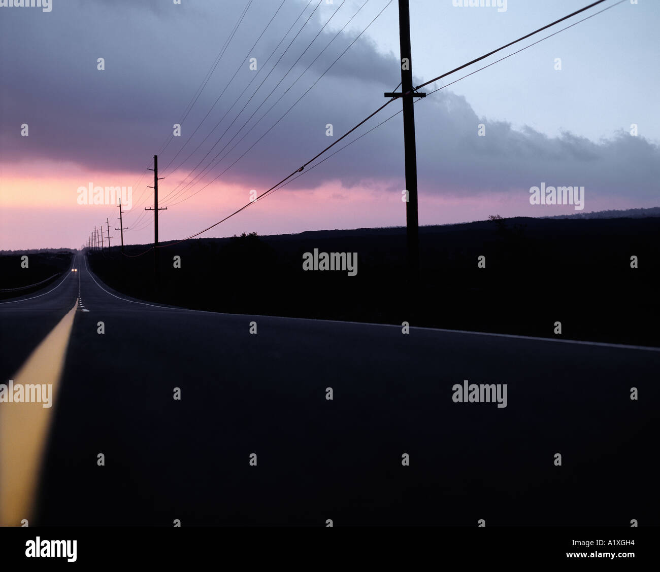 Car approaching on desolate country road Stock Photo - Alamy