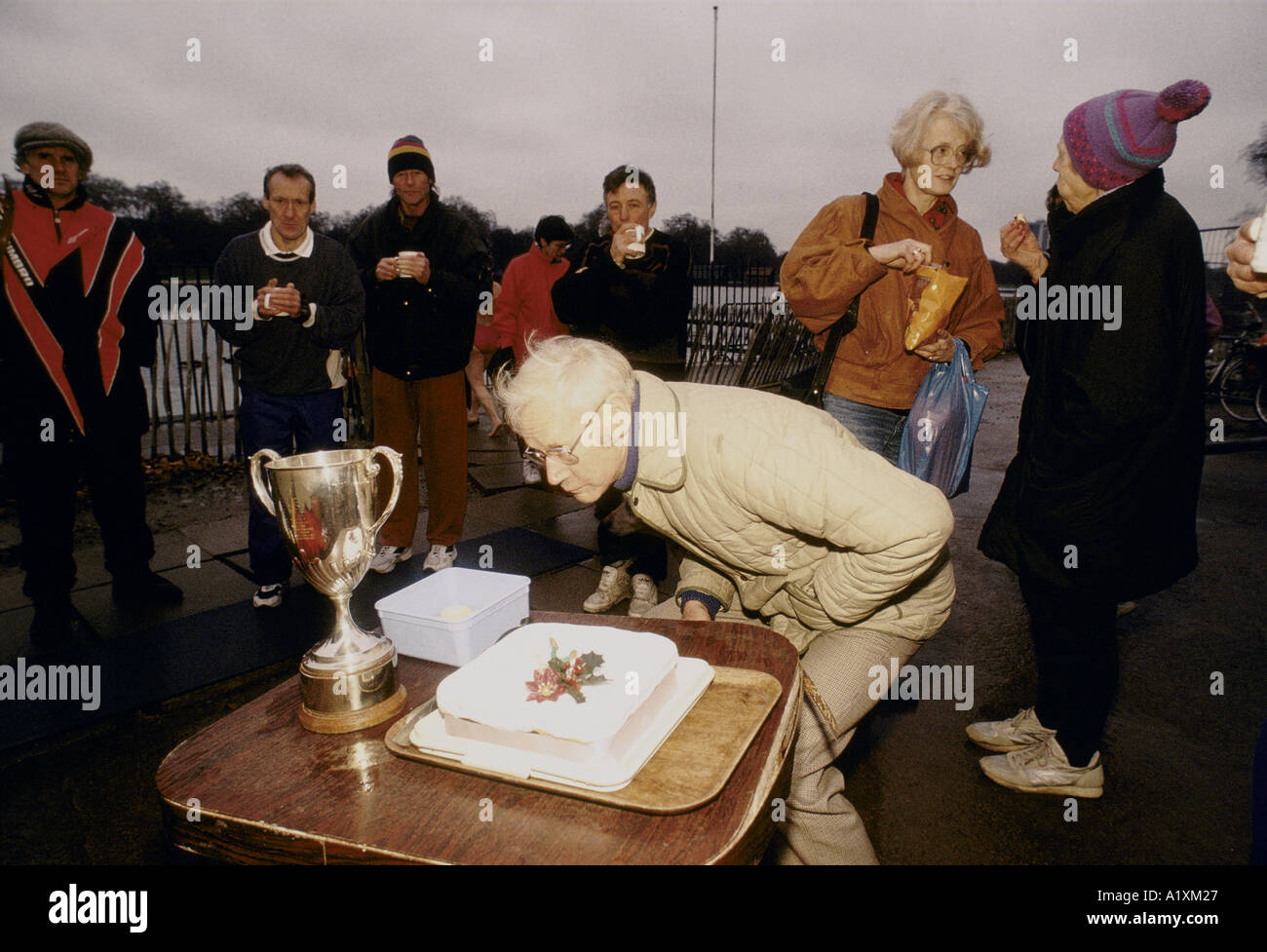 AN OLDER MAN EXAMINES THE CAKE AND PETER PAN CUP FOR THE SERPENTINE ...