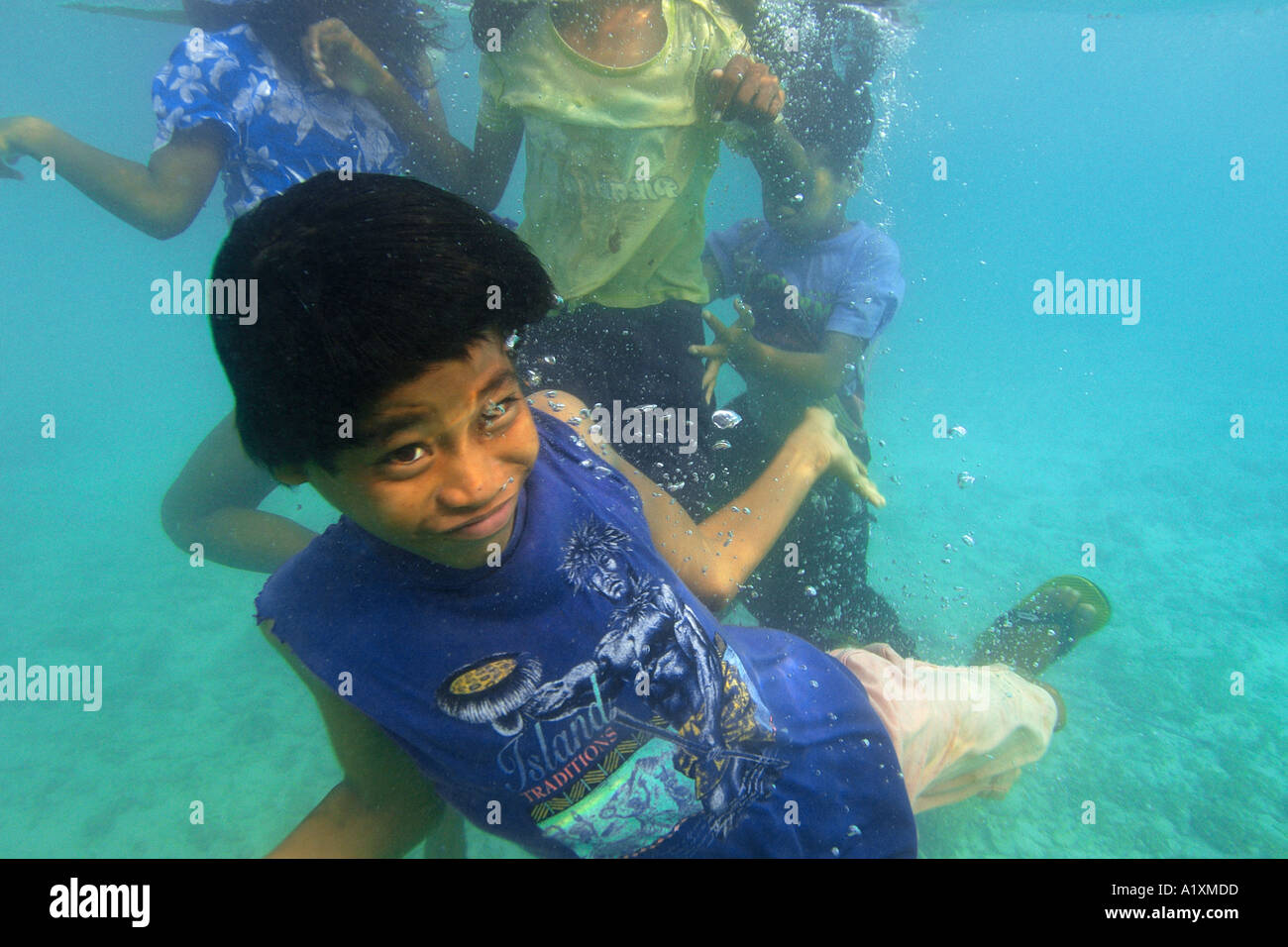 Kids diving next to sandy bottom Majikin Island Namu atoll Marshall ...