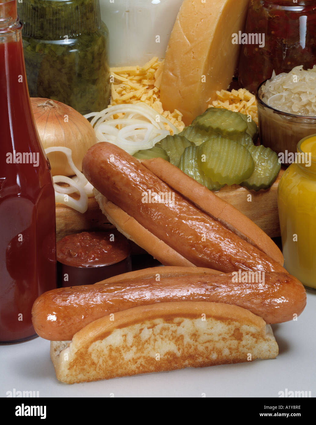 2 two hot dog roll bun condiments mustard catsup ketchup onion cheese ...