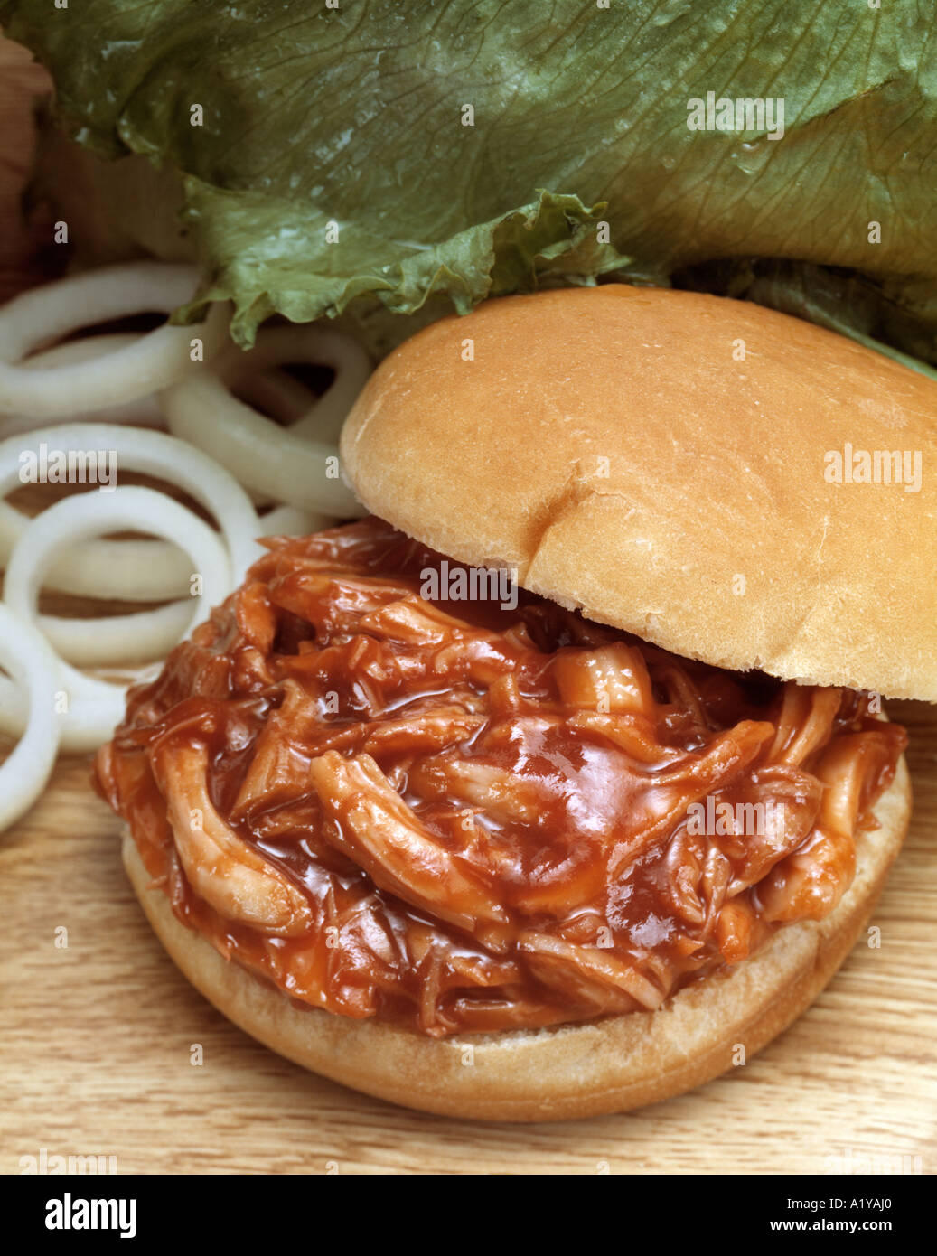 close up pork bbq barbeque sandwich roll onion rings french fry fries ...