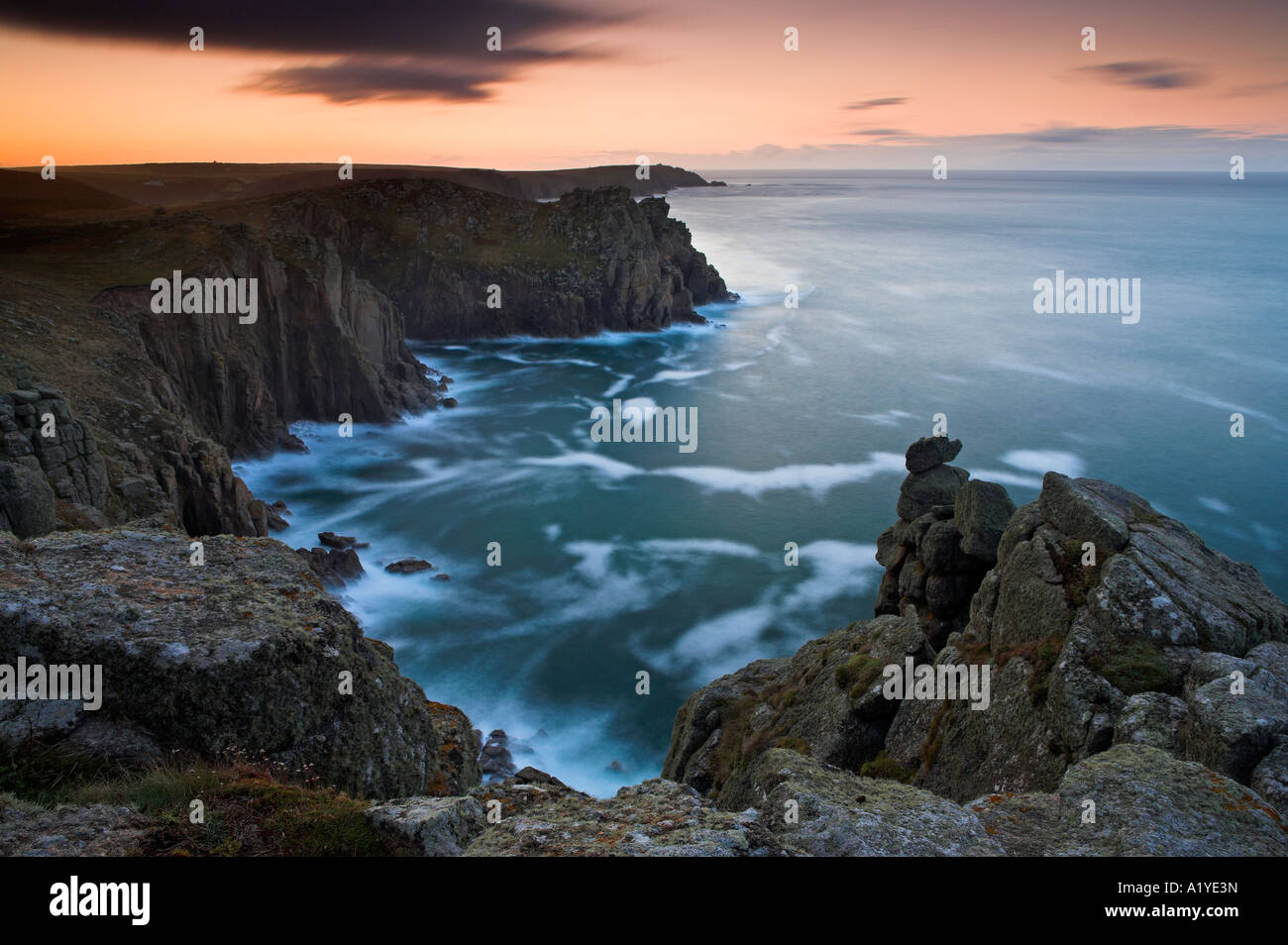 Swirling tide around the base of the huge cliffs of Land s End ...