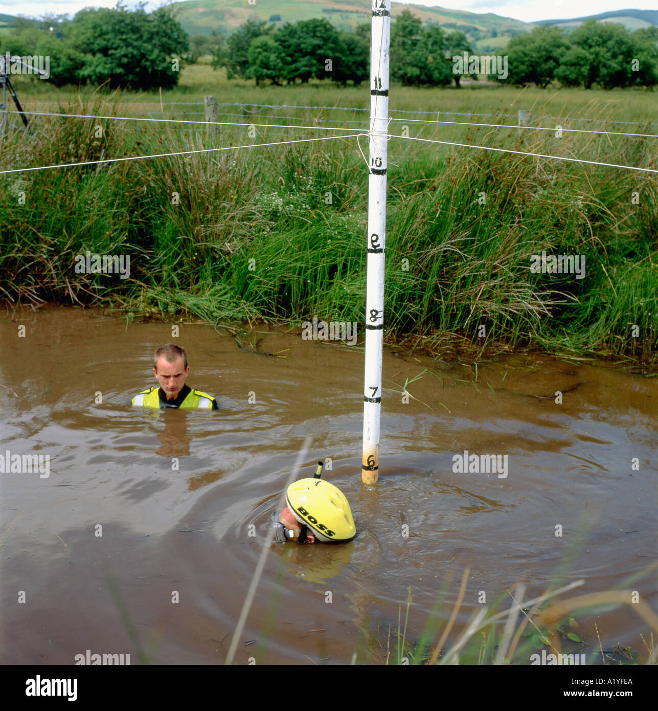 A contestant sunk under water with helmet visible in the mountain ...