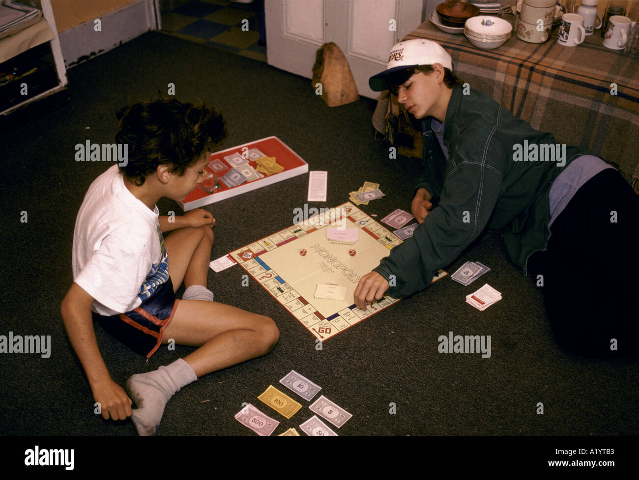 TWO BOYS PLAYING MONOPOLY 1993 Stock Photo - Alamy