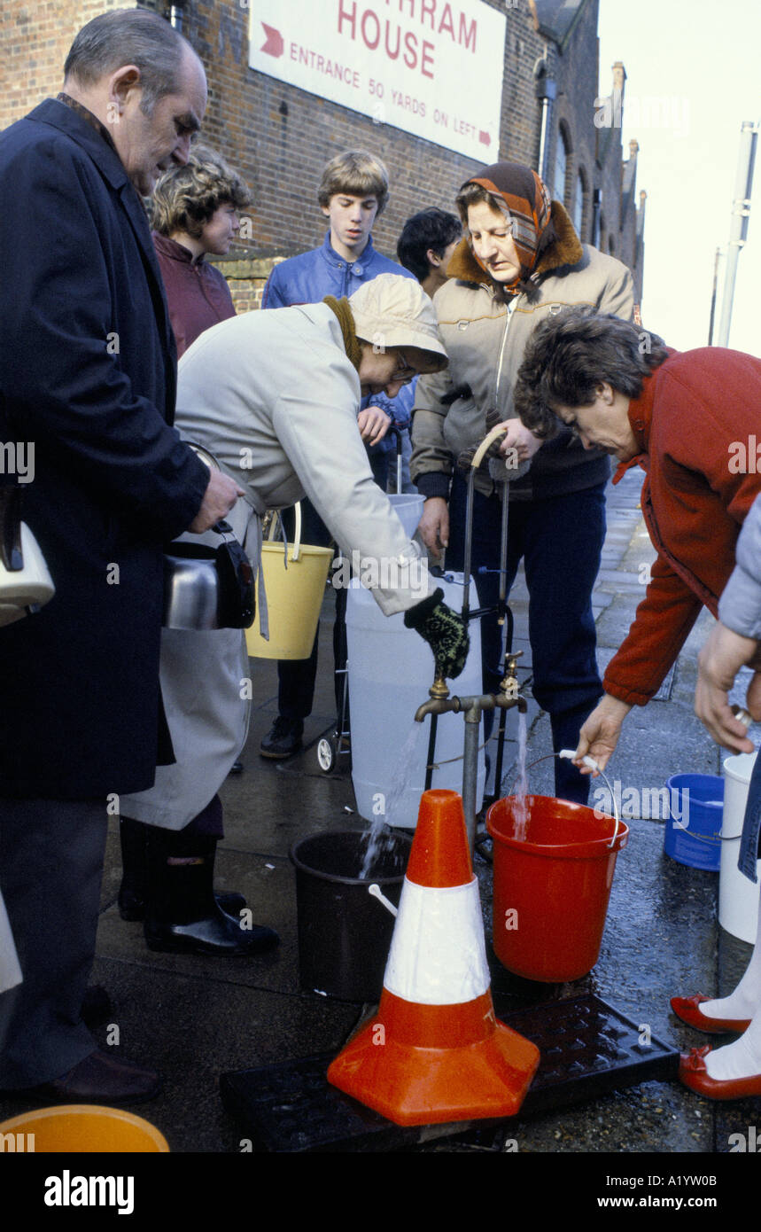 PEOPLE COLLECTING WATER WITH BUCKET USING STANDPIPES ON STREET Stock ...