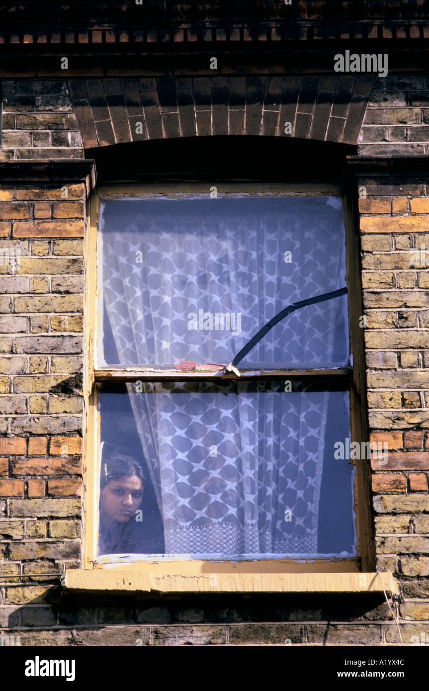 WOMAN LOOKING OUT WINDOW OLD HOUSE BRICK LANE EAST LONDON Stock Photo ...