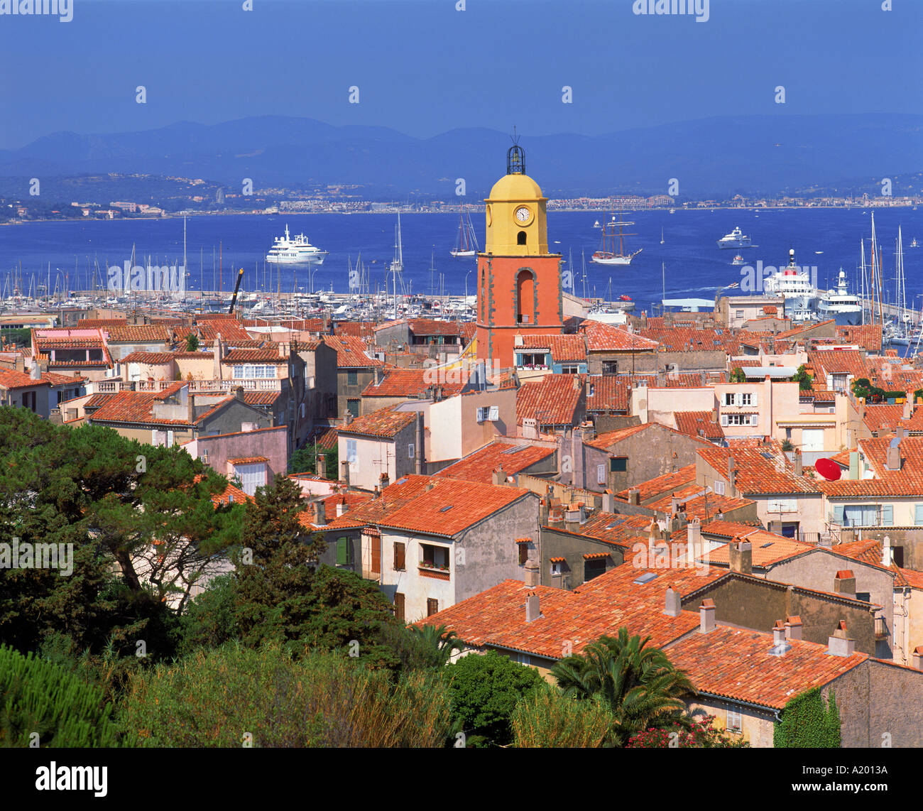 The town skyline with ships in the bay in the background at Portofino ...