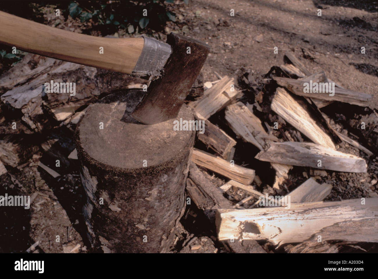 Axe in chopping block Stock Photo - Alamy