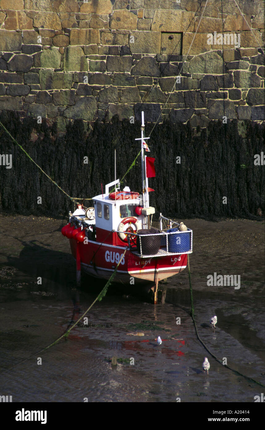 Fishing boat at low water St Peter Port Guernsey Stock Photo - Alamy
