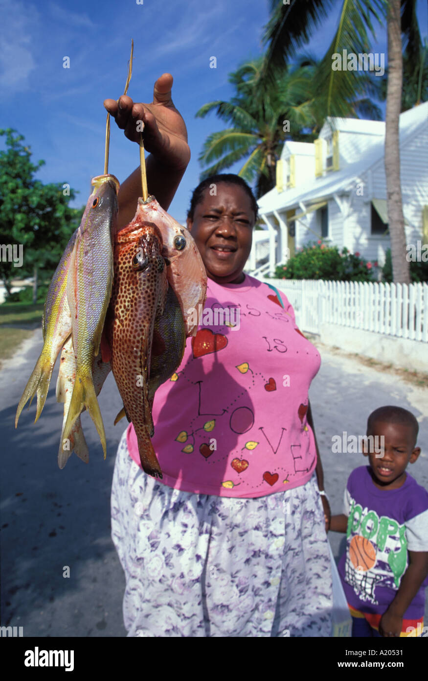 Woman holding fish with her son Stock Photo - Alamy