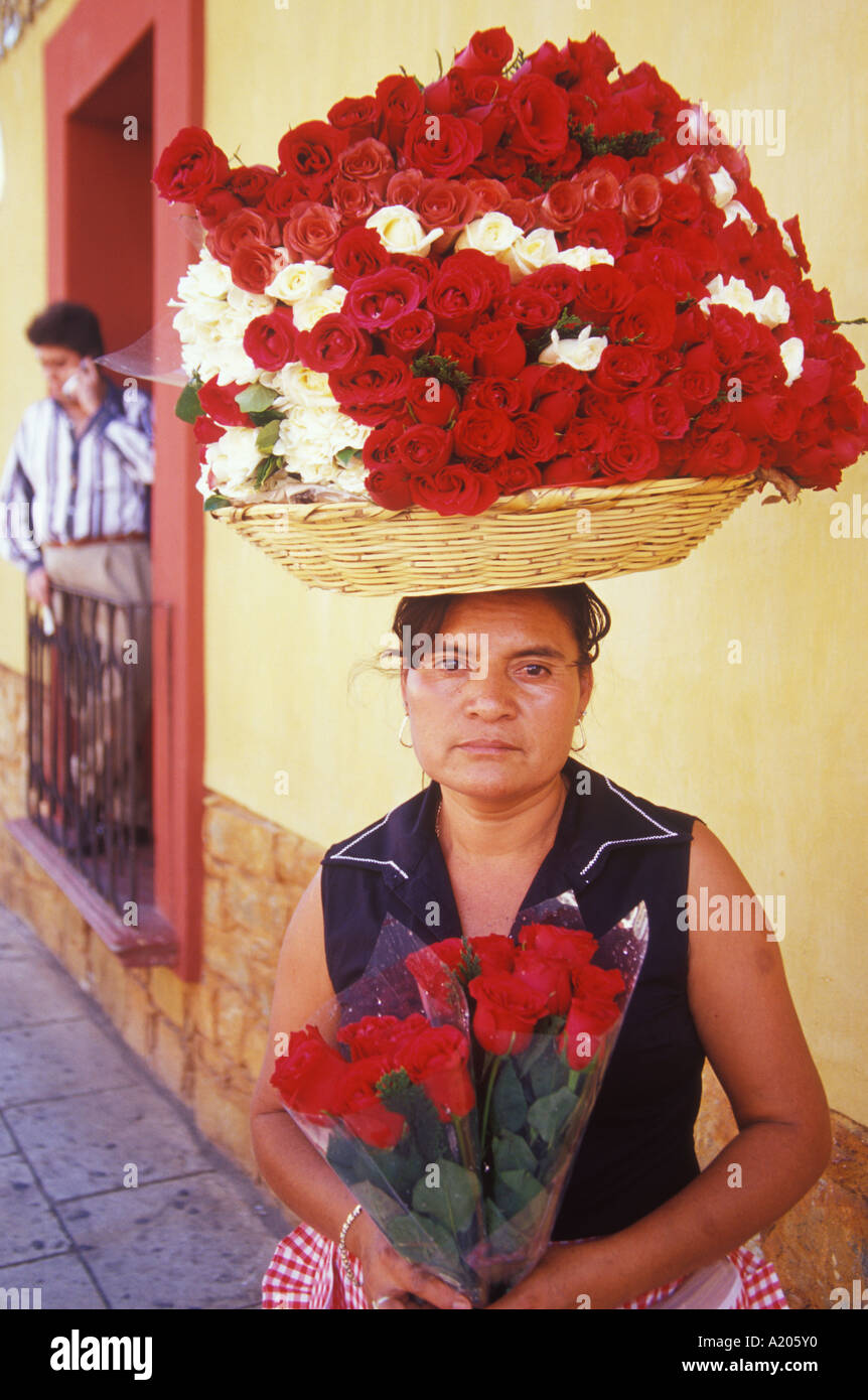 street vendor selling roses as a business man talks on a cellular phone ...