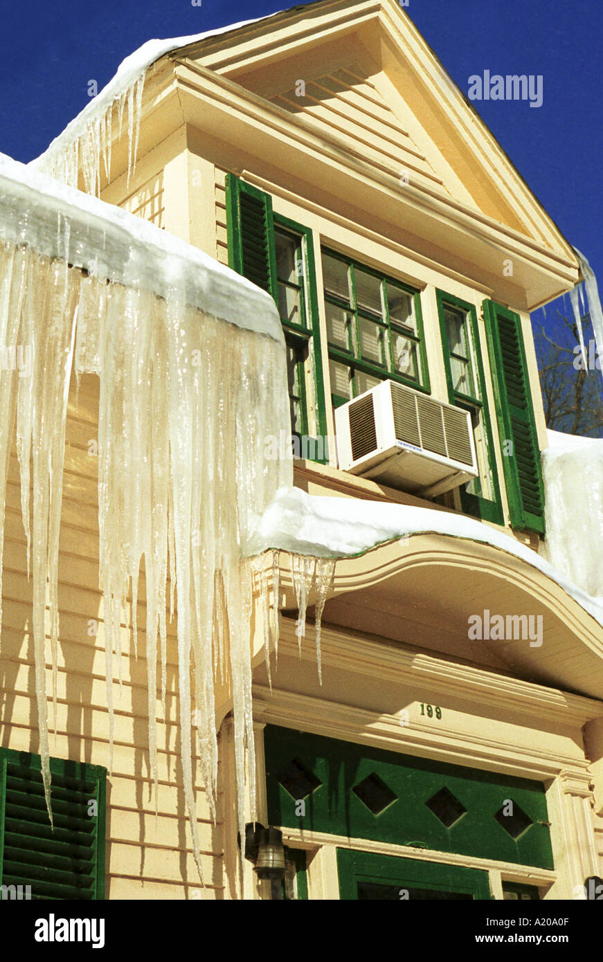 Yellow house with icecicles in winter Fredericton New Brunwick Canada ...