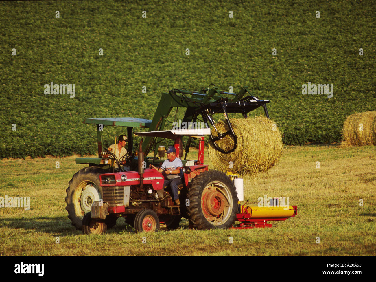 Tractor baling hay at sunset hi-res stock photography and images - Alamy