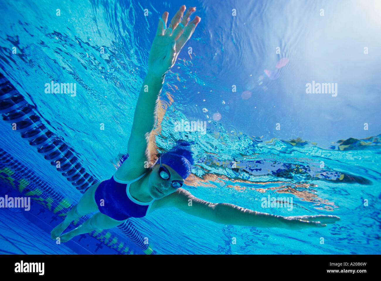 Woman swimming floating underwater, (low angle view Stock Photo - Alamy