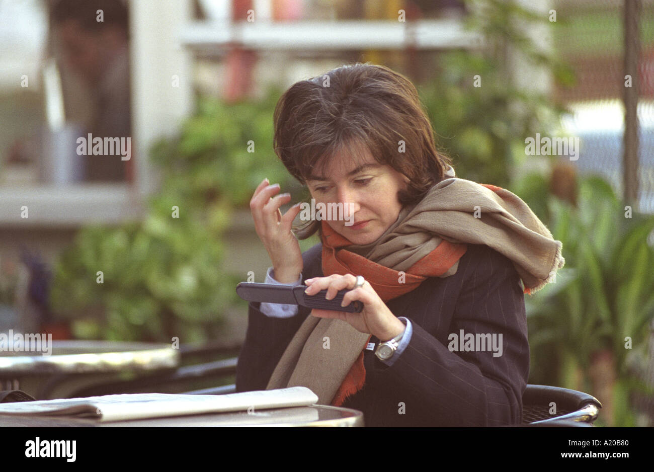 Woman checking her makeup in an outdoor cafe Stock Photo - Alamy
