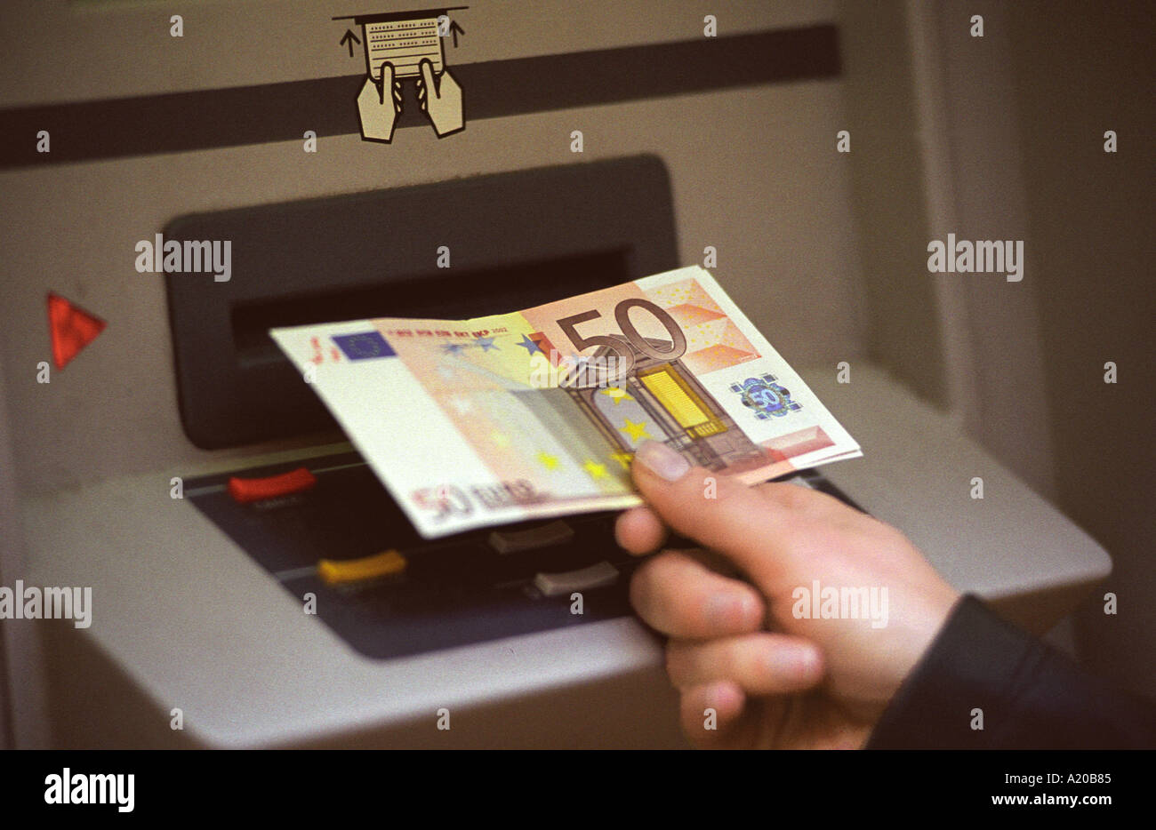 Withdrawing Euro notes from cash machine Stock Photo - Alamy