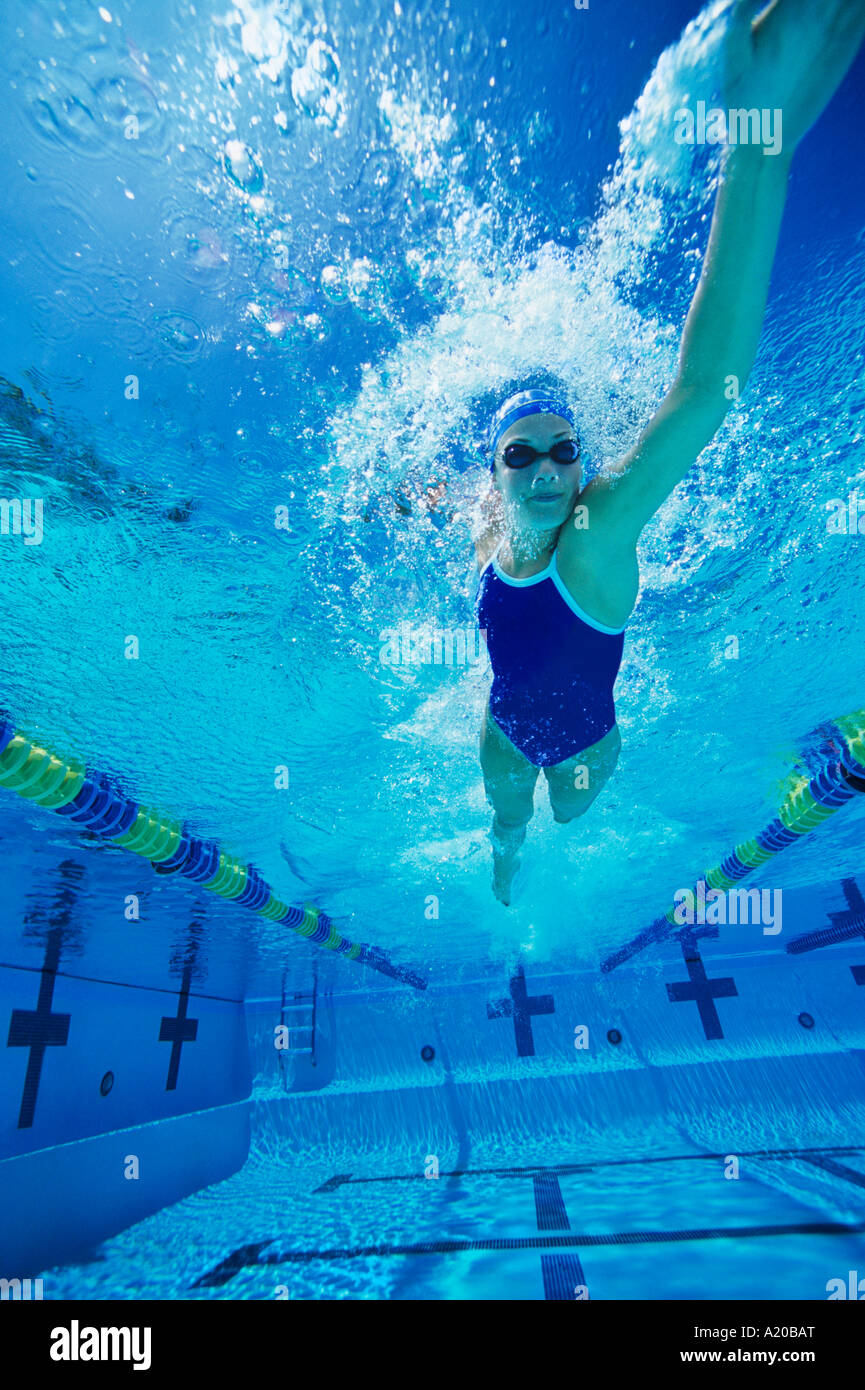 Female swimmer racing underwater in pool Stock Photo - Alamy
