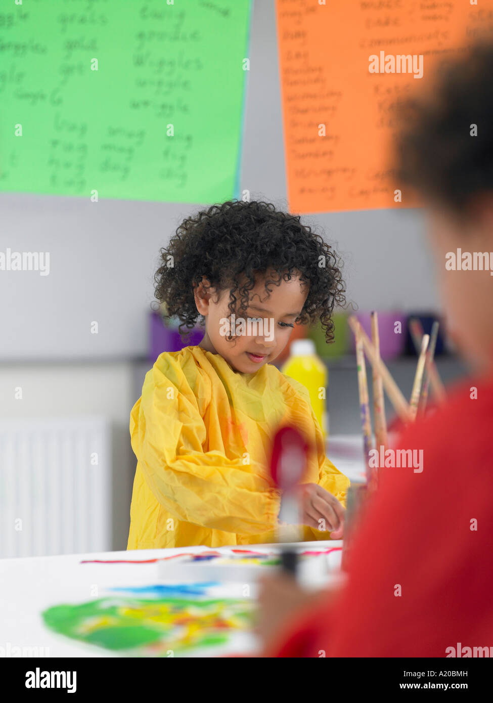 Elementary students painting in art class Stock Photo - Alamy
