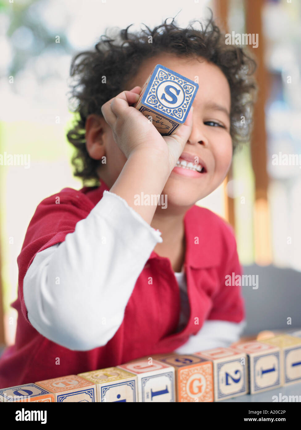 Boy playing with alphabet blocks, portrait Stock Photo - Alamy