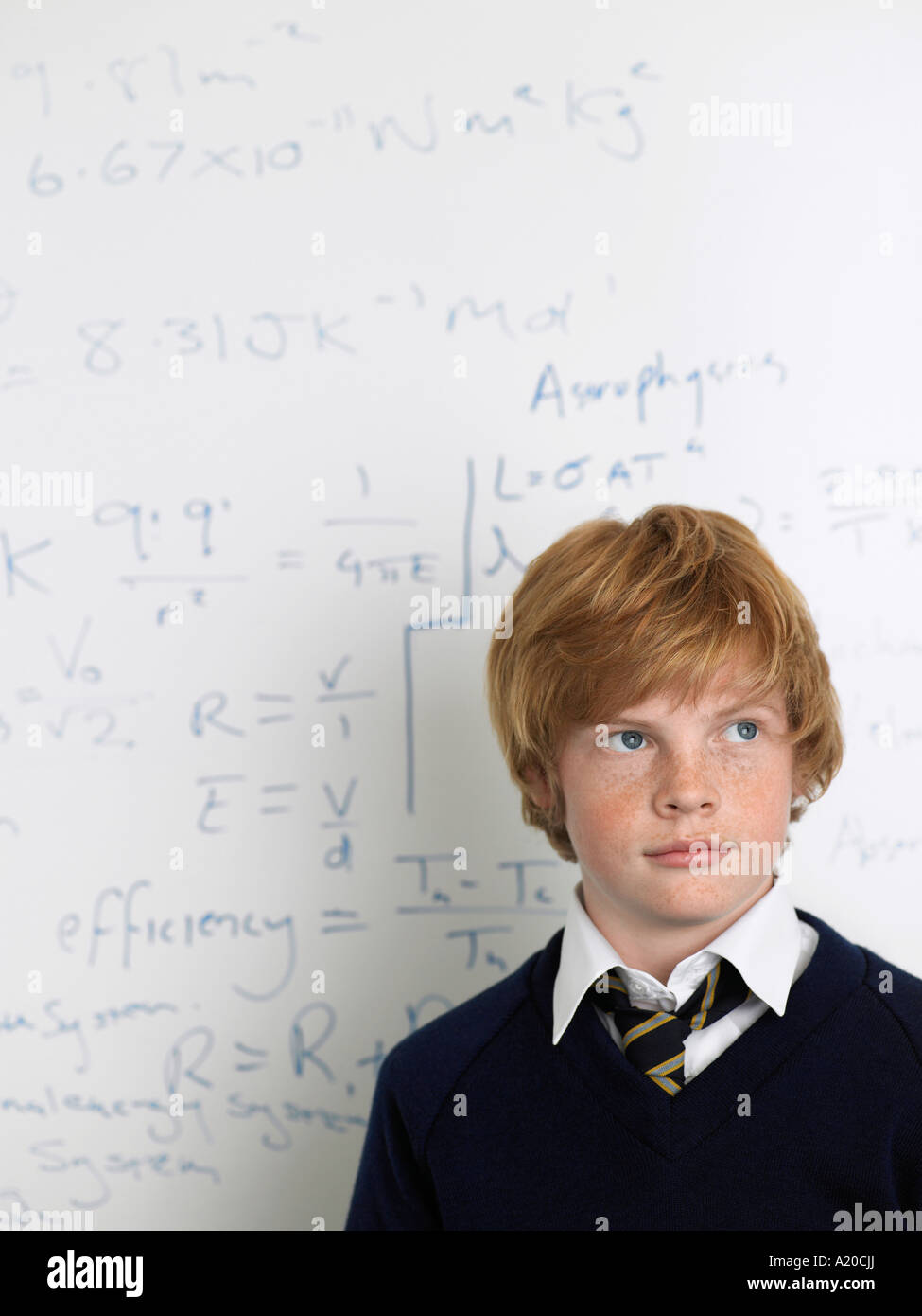 Elementary school student standing by whiteboard in math class Stock ...