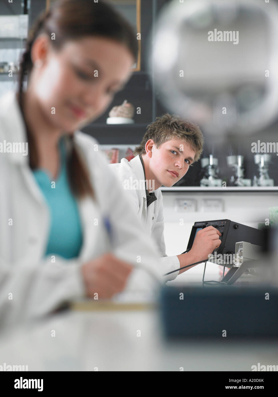 Teenagers working in science class Stock Photo - Alamy