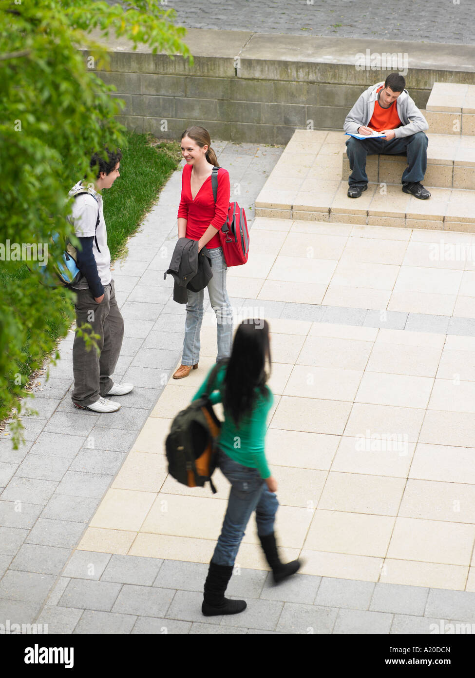 Students sitting and standing on school grounds outdoors, elevated view ...