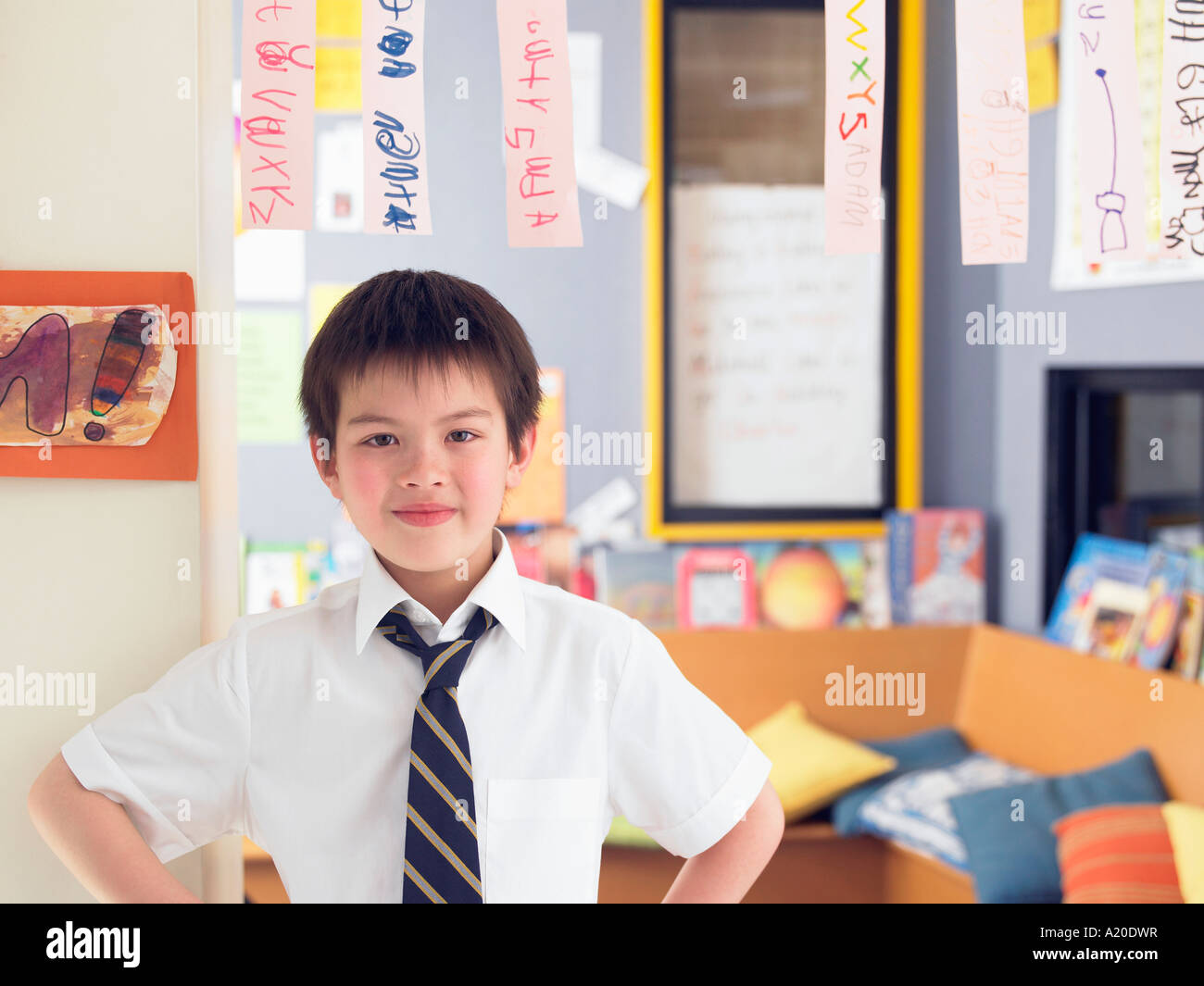 Elementary schoolboy standing in classroom, portrait Stock Photo - Alamy