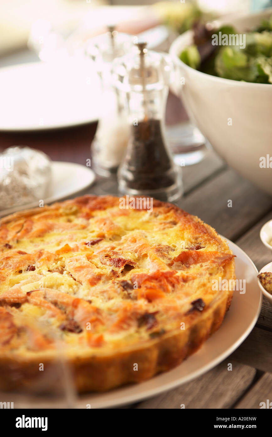 Plate of Quiche setting on picnic table among other dishes Stock Photo ...
