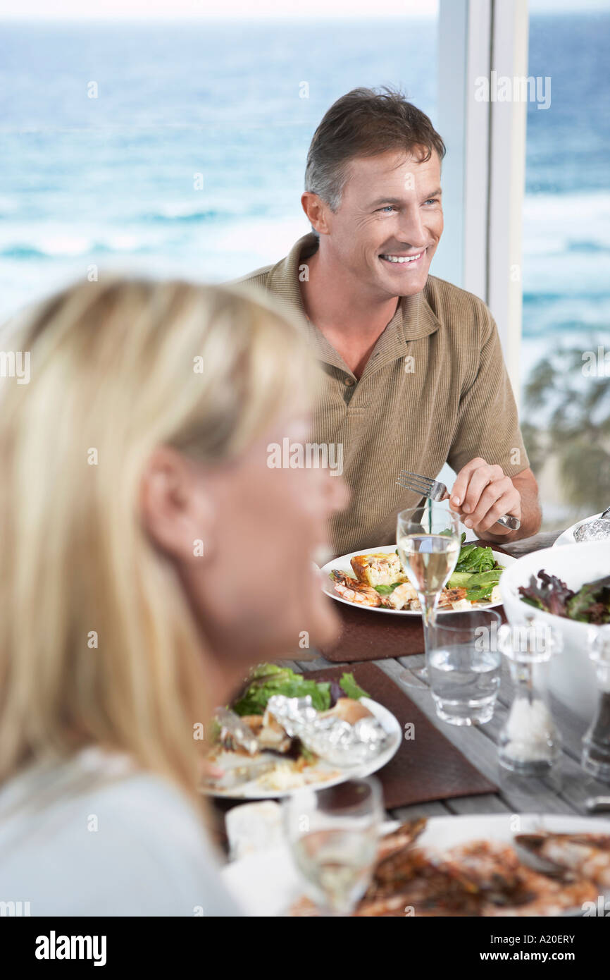 Smiling Man Eating meal outside near the sea Stock Photo - Alamy
