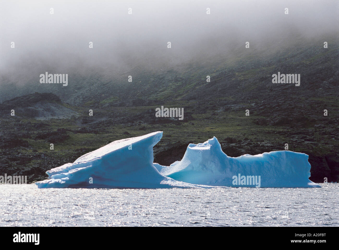 Small iceberg in front of rocks Stock Photo - Alamy