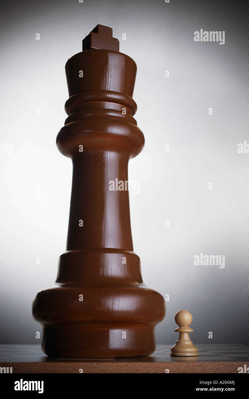Two chess pieces, large king and small pawn Stock Photo - Alamy