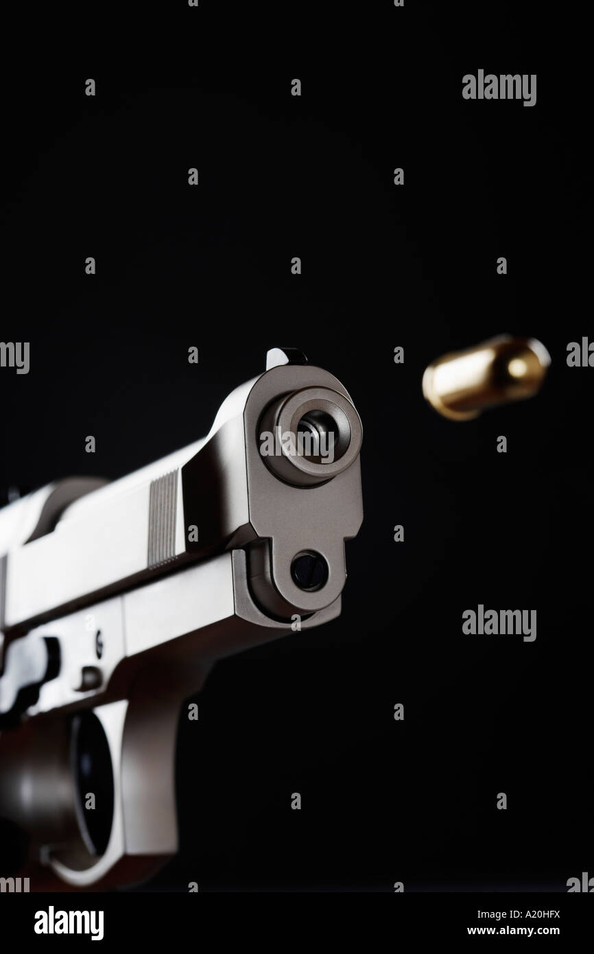 Gun shooting bullet on black background, close up Stock Photo - Alamy