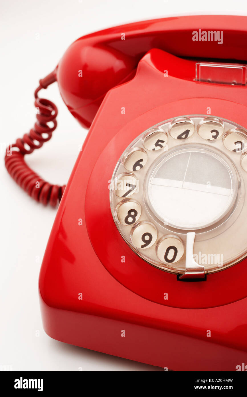 Old fashioned red telephone in studio, cropped Stock Photo - Alamy