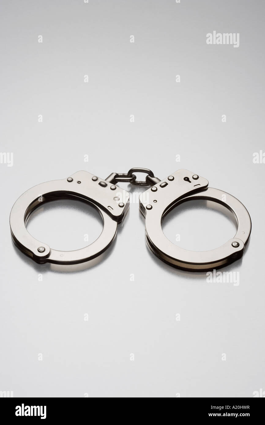 Handcuffs on white background in studio Stock Photo - Alamy
