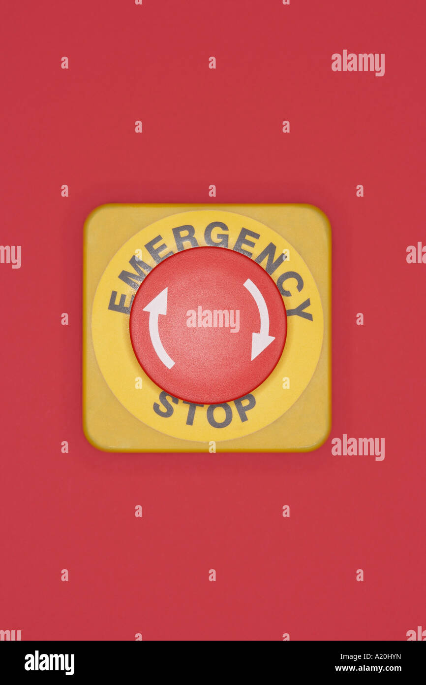 Emergency stop button on red background Stock Photo - Alamy