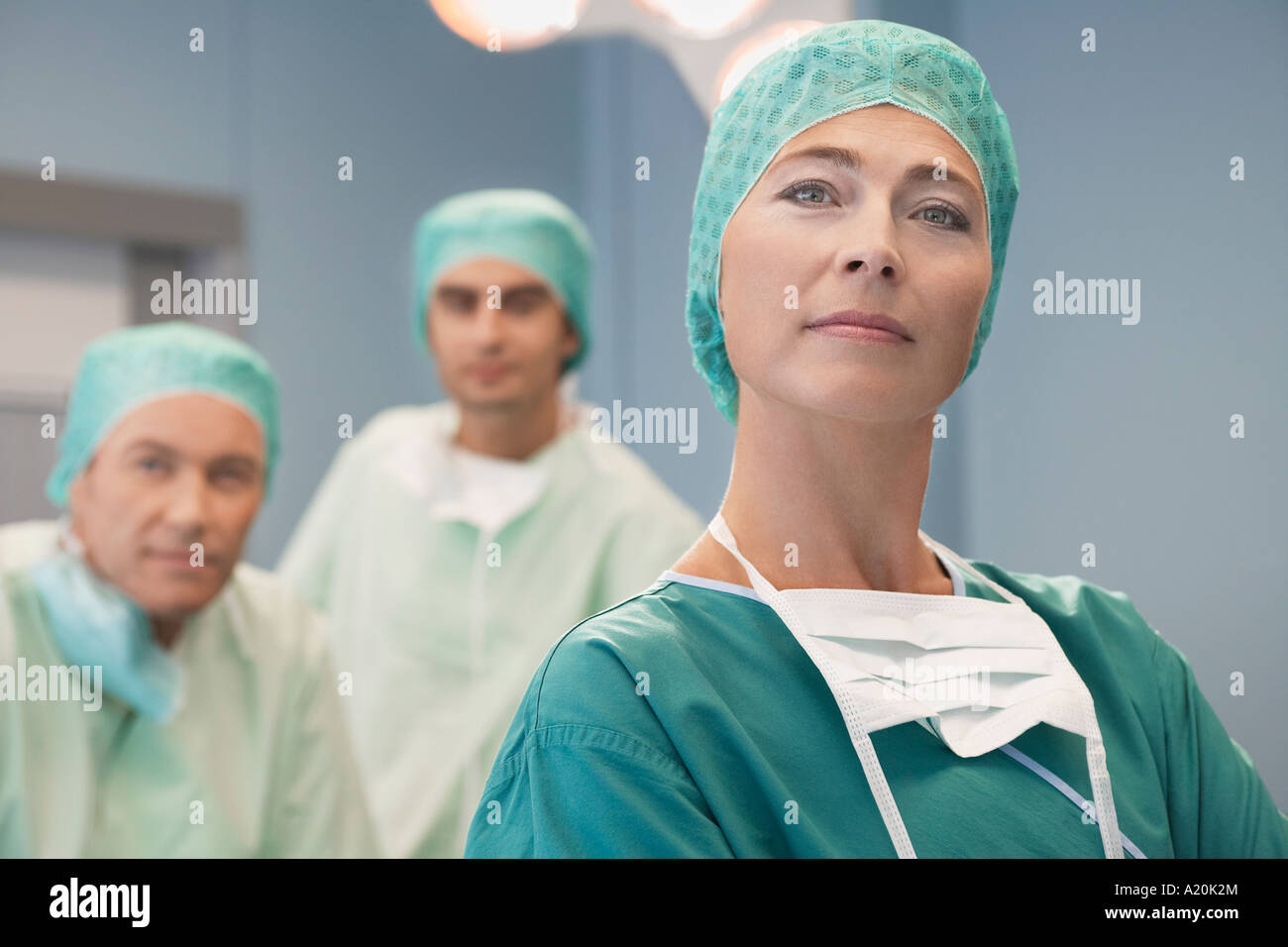 Head of Surgical Team with surgeons in operating theatre, portrait ...