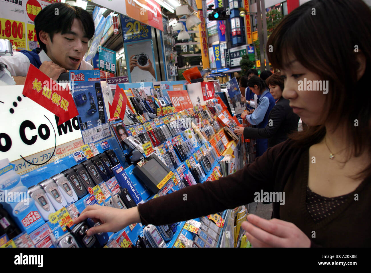 viewing the displays of mobile telephones outside a shop in the ...