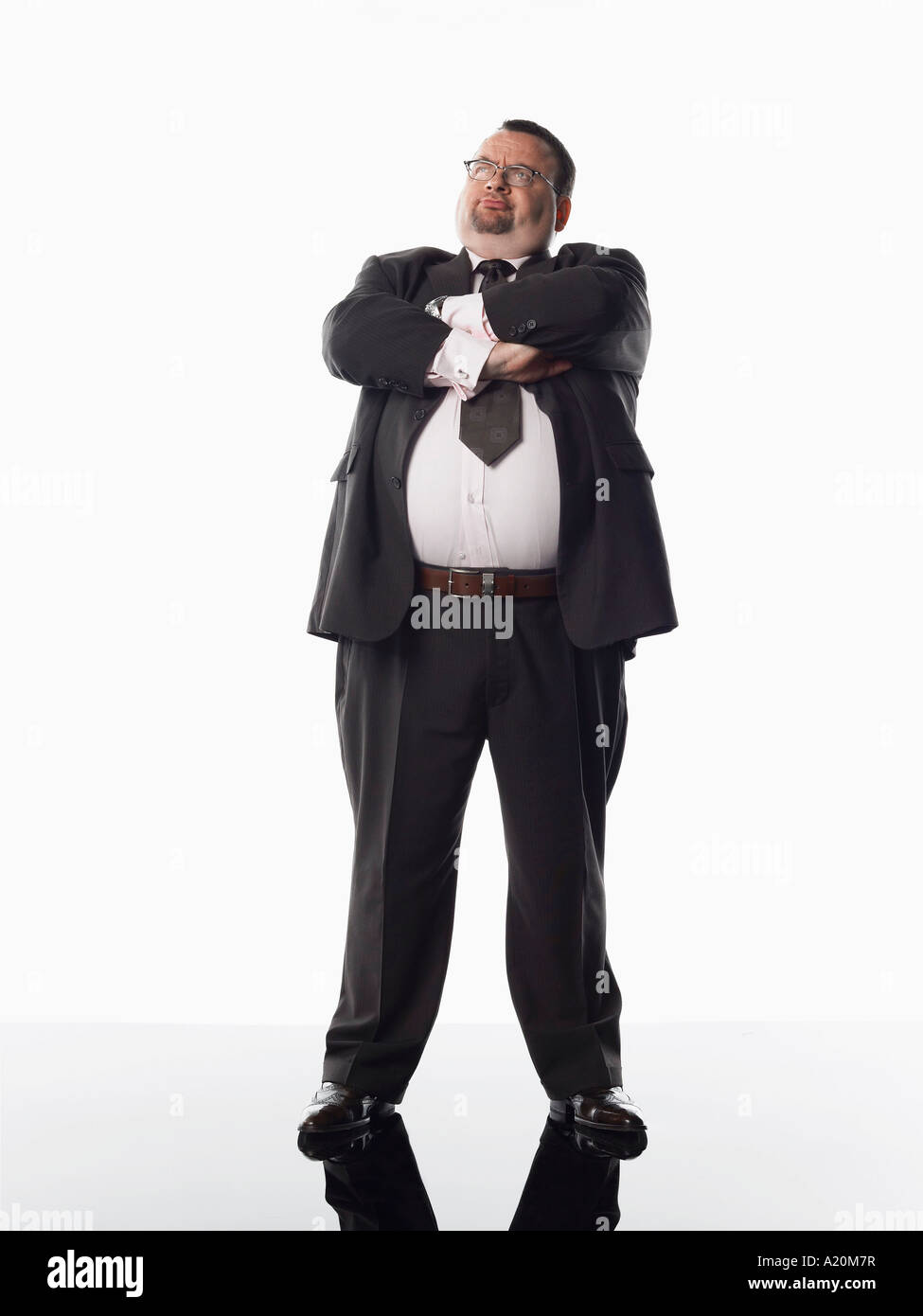 Overweight businessman standing with arms folded Stock Photo - Alamy