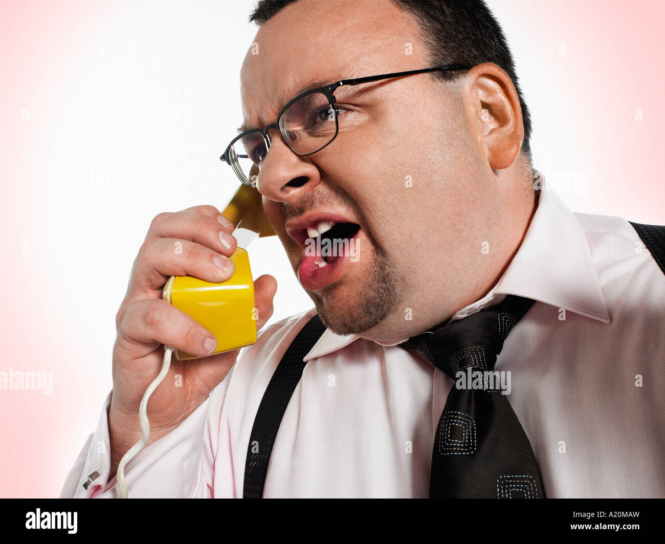 Businessman yelling into phone, close-up Stock Photo - Alamy