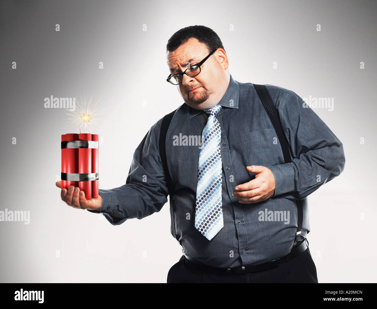 Businessman holding sticks of dynamite Stock Photo - Alamy