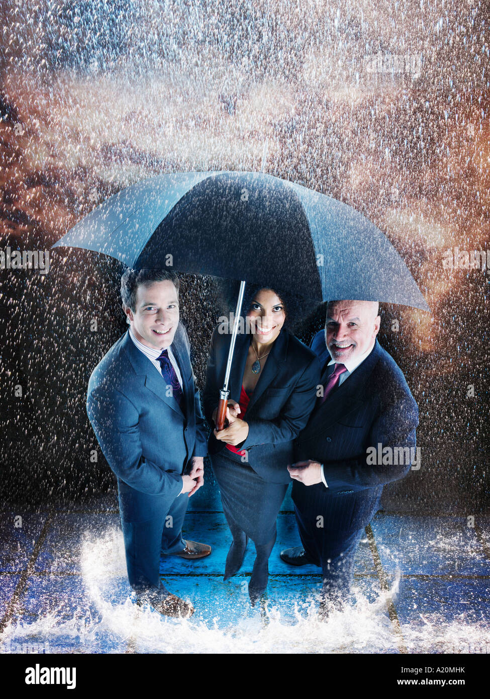 Businesspeople under one umbrella Stock Photo - Alamy