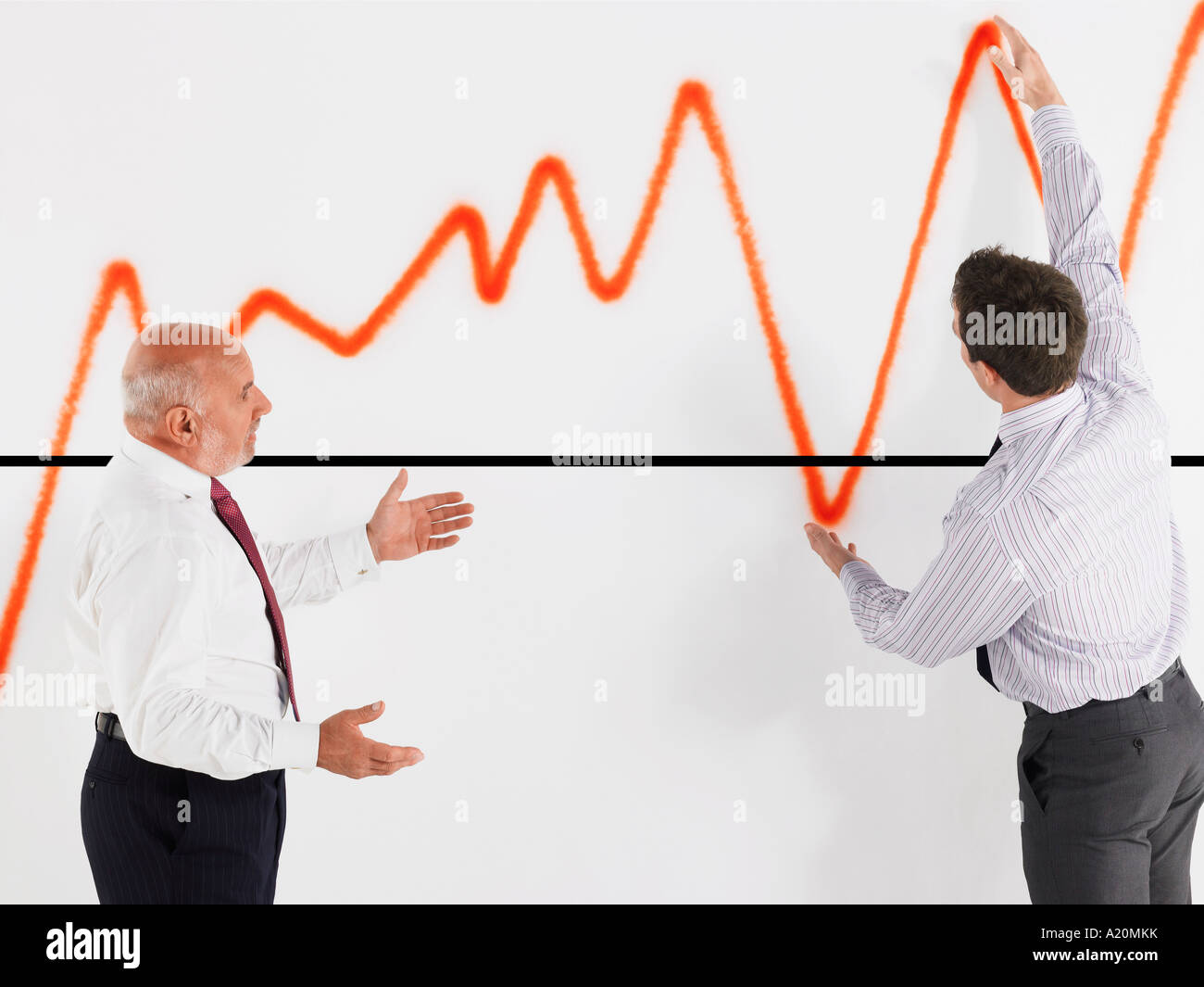 Businessmen looking at graph Stock Photo - Alamy
