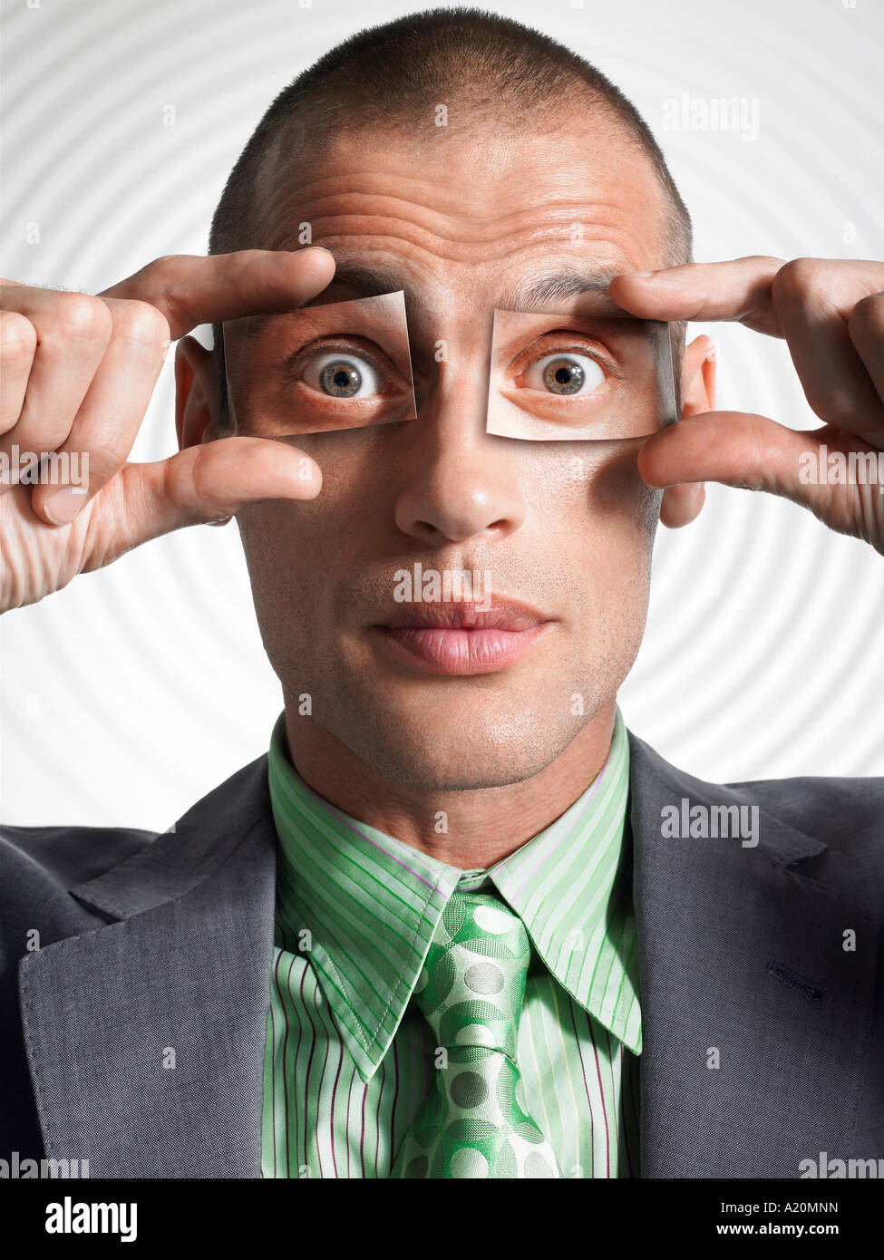 Businessman holding photos of eyes in front of his own eyes Stock Photo ...