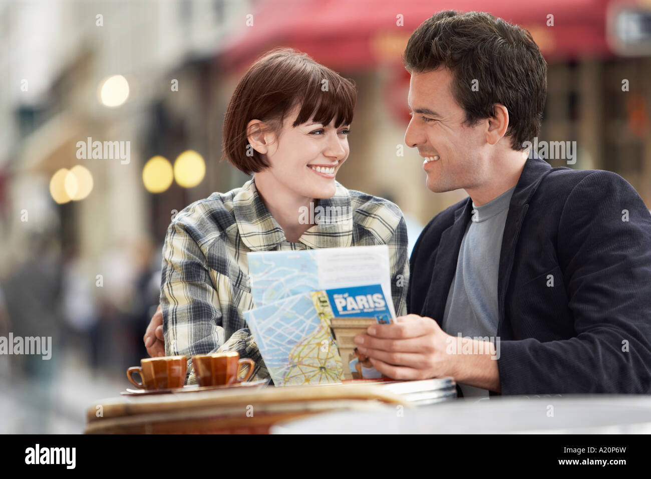 France, Paris, Couple reading map sitting outside cafe Stock Photo - Alamy