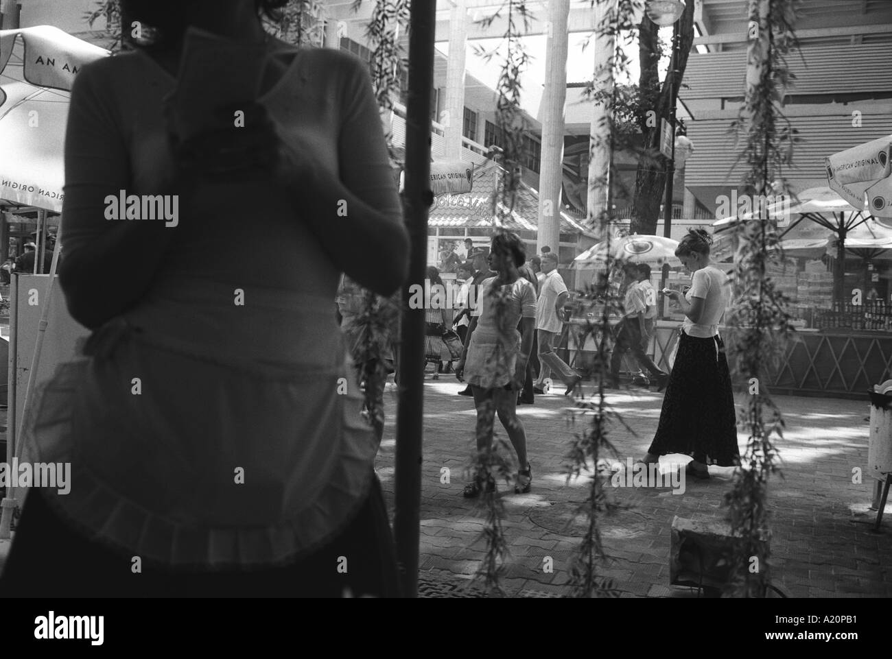 Waitresses look for customers outside their restaurants in Tashkent a ...