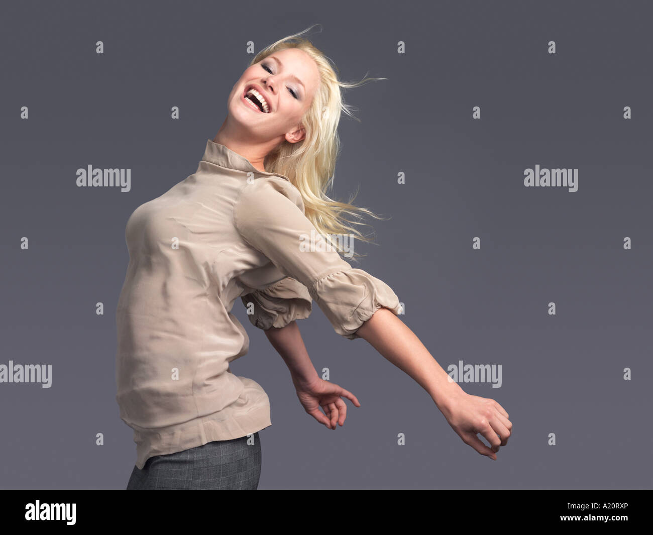Smiling woman standing, arms outspread, side view Stock Photo - Alamy