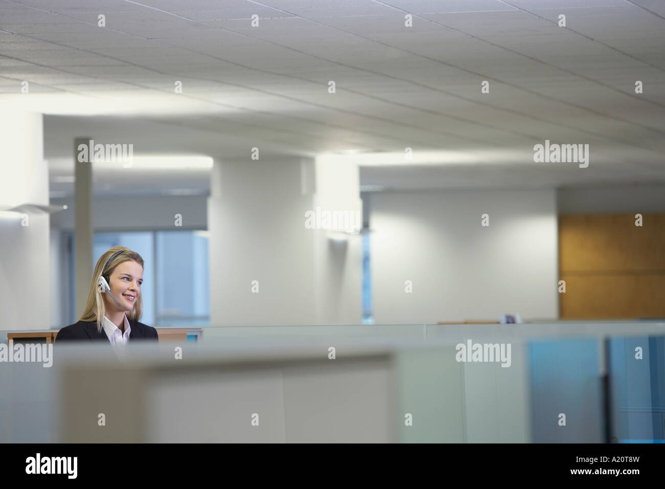 Receptionist sitting at reception desk Stock Photo - Alamy