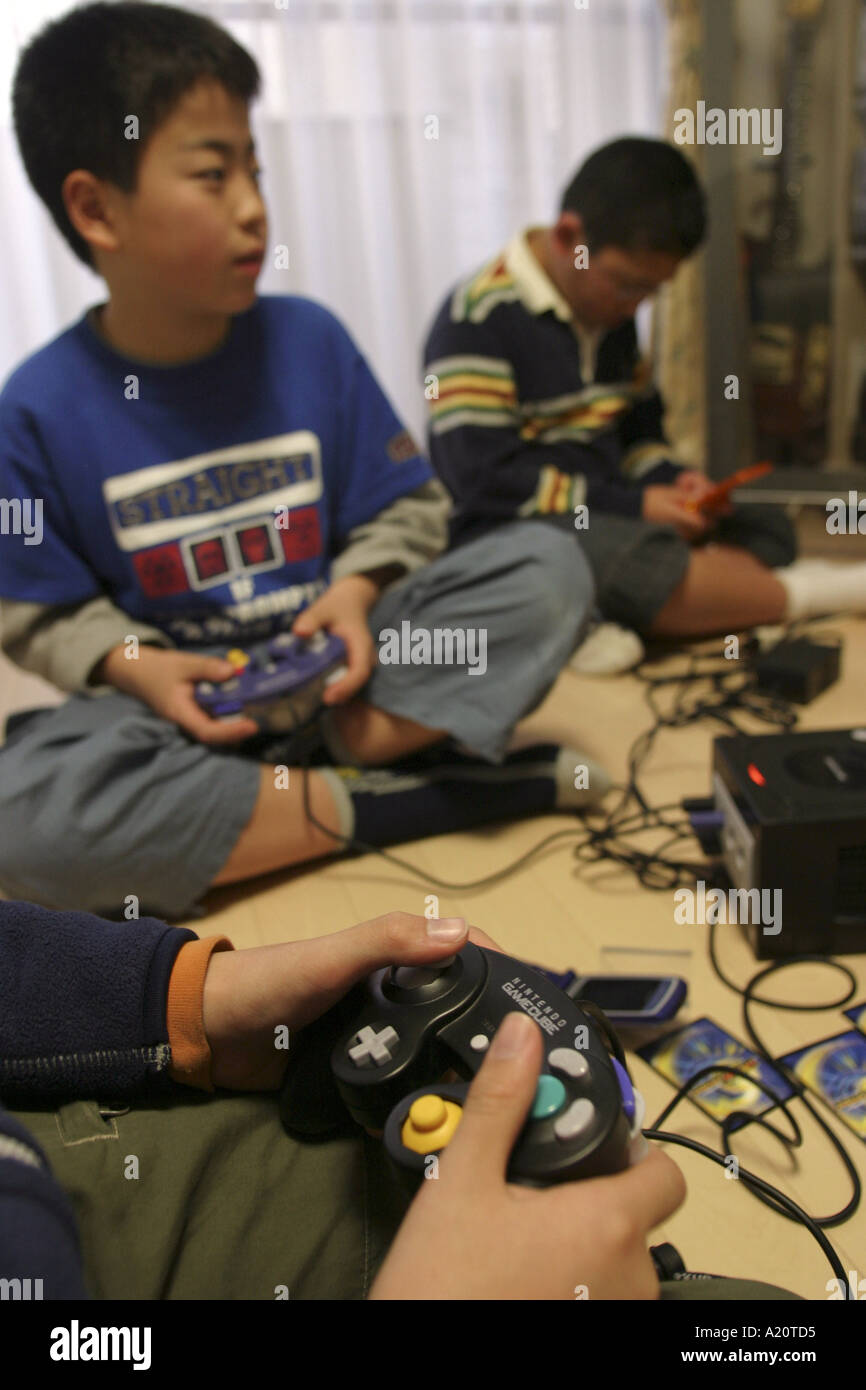 Japanese children playing Nintendo Gamecube and Gameboy, Tokyo, Japan ...