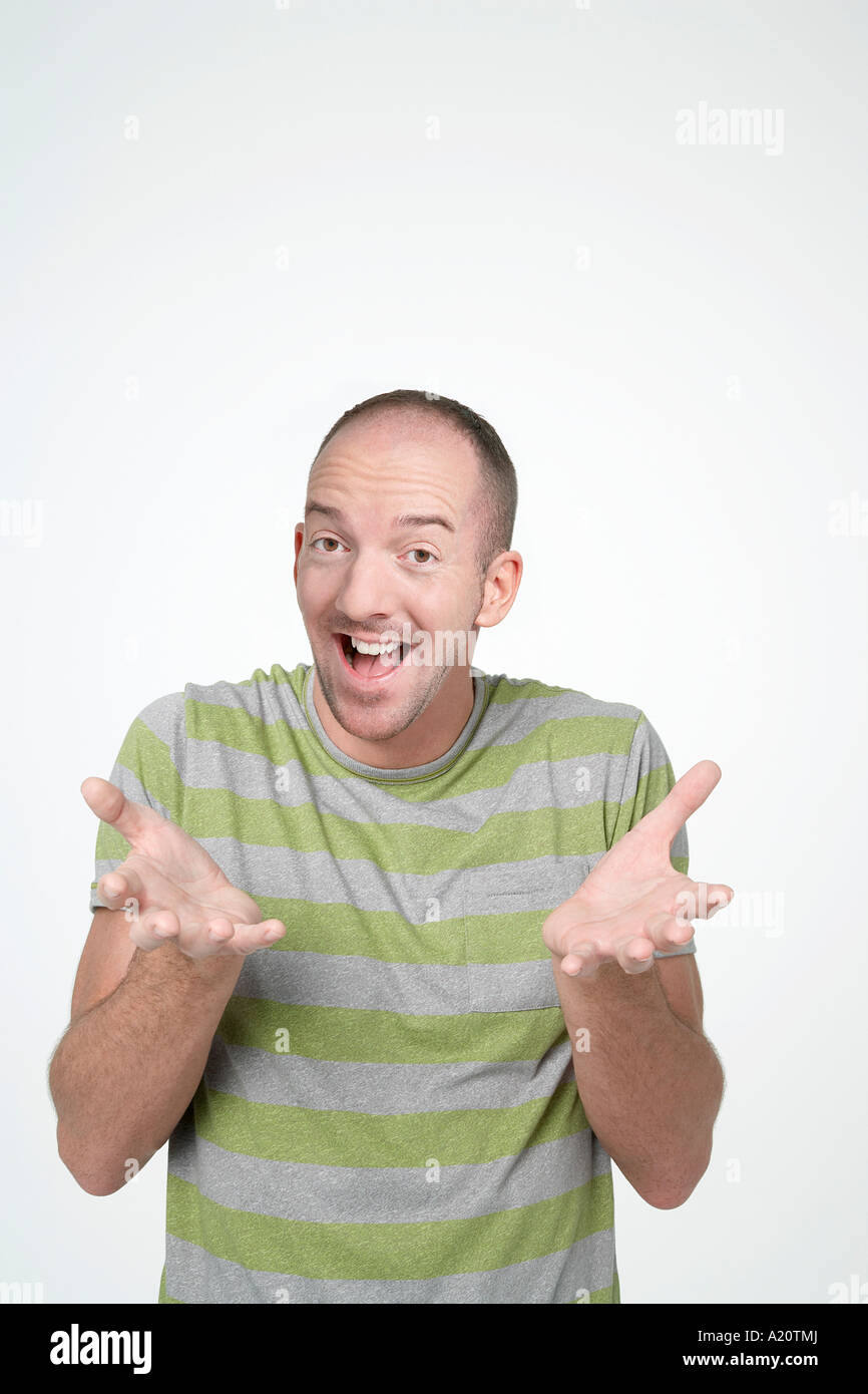 Smiling Man, hands raised, Shrugging Stock Photo - Alamy